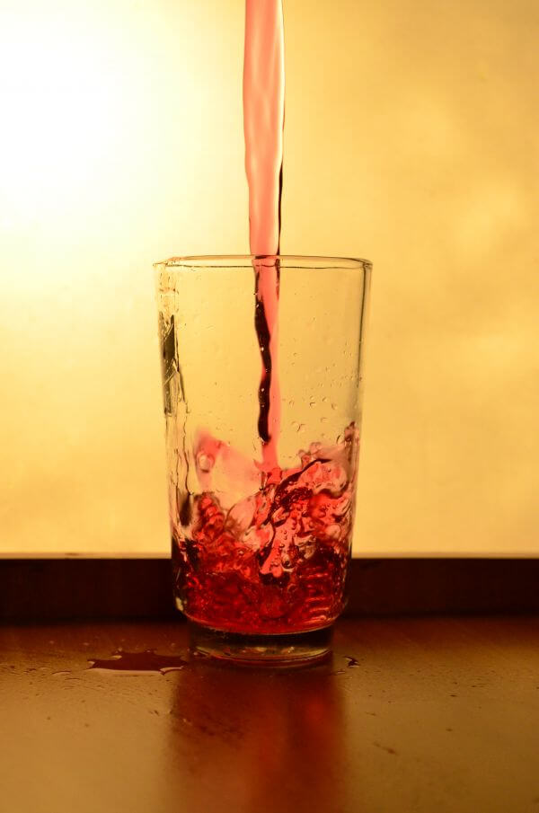 Free photo "Red Liquid Falling Glass"